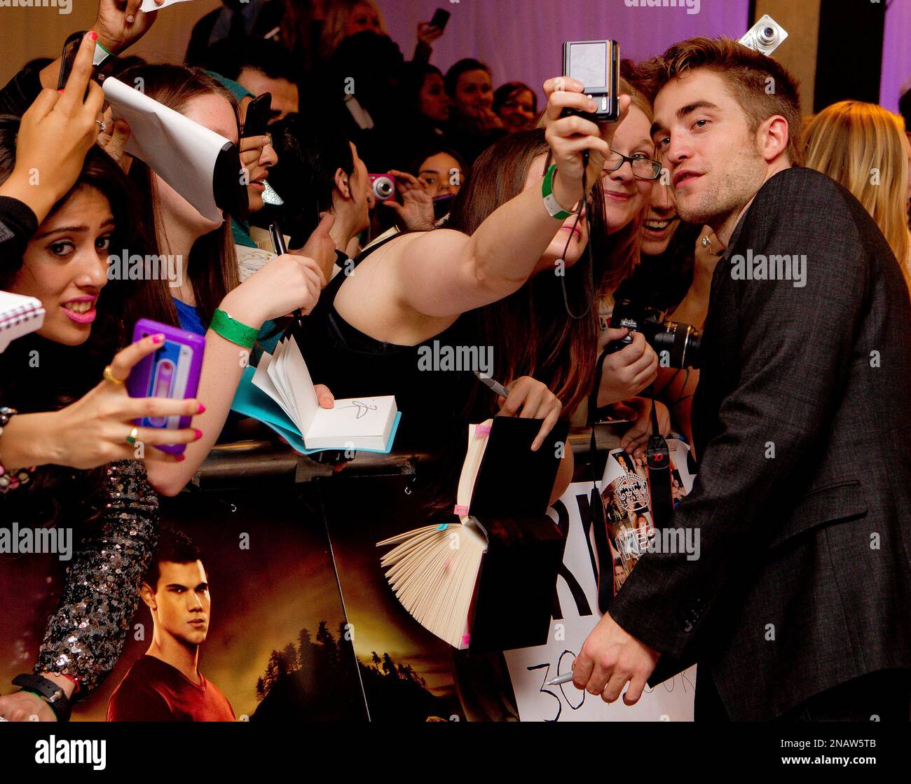 British actor Robert Pattinson poses for fans as he arrives at the UK ...