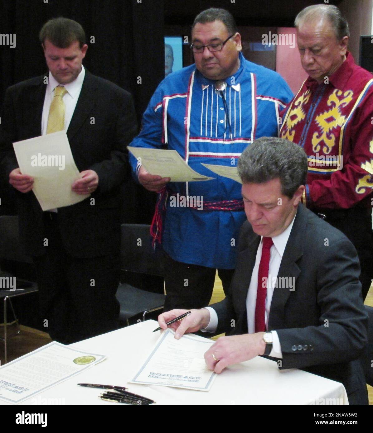 Tribal leaders watch as Kansas Gov. Sam Brownback signs a proclamation ...