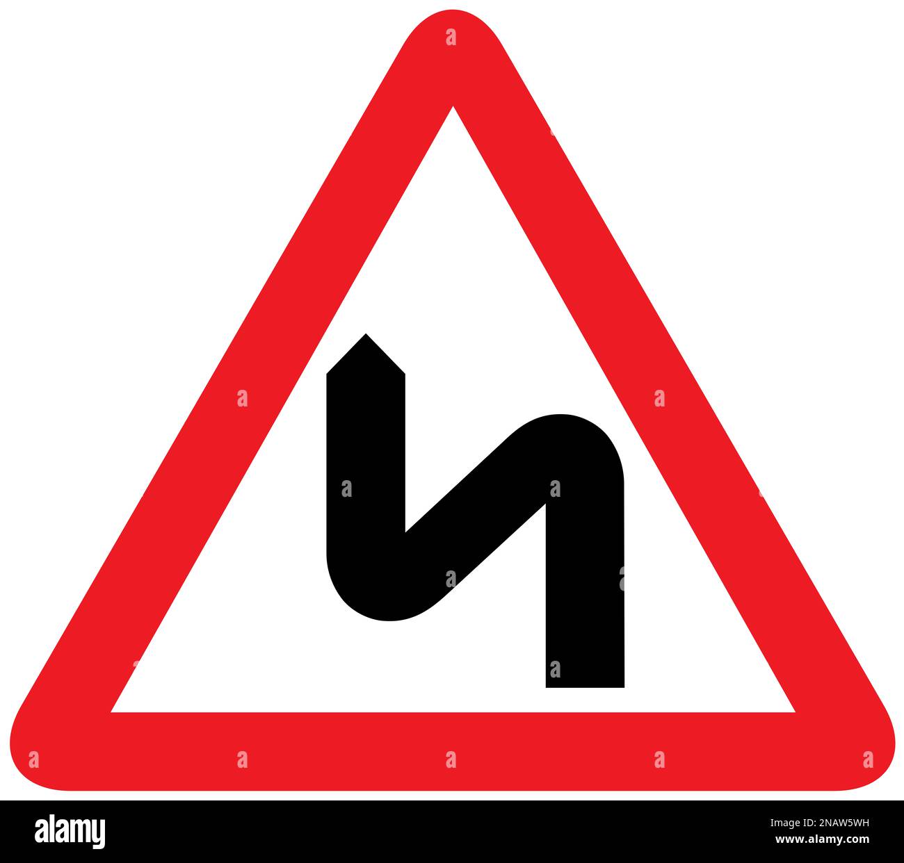 Double bend first to the left British road sign Stock Photo - Alamy