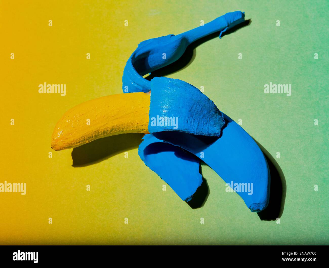 Abstract image of a multi-coloured banana on a colour gradient ...