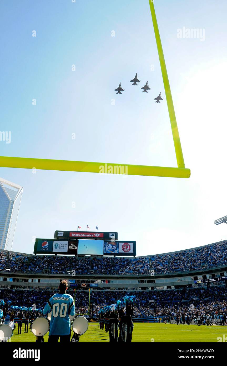 Military jets fly over the Bank of America Stadium prior to an NFL ...