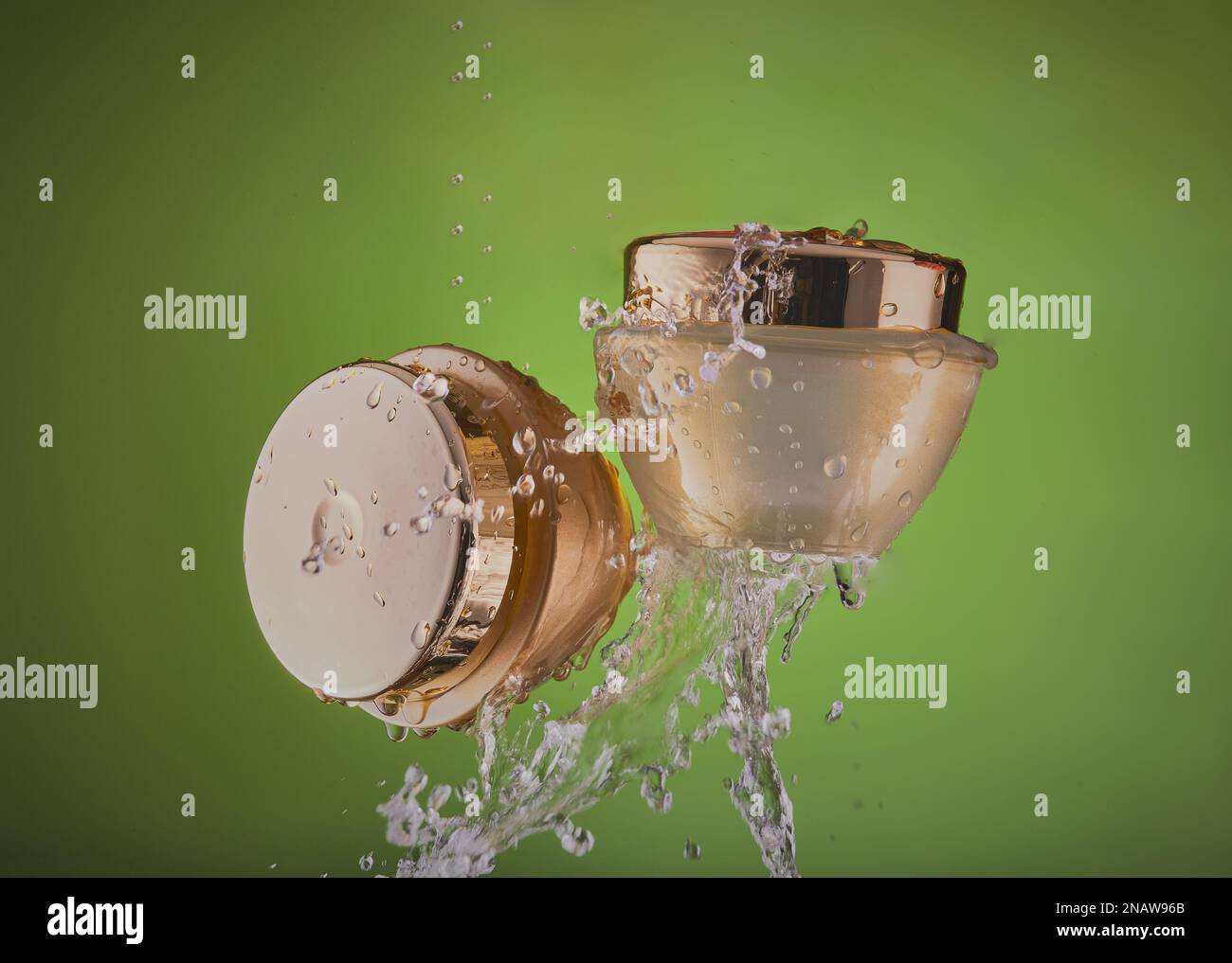 Cosmetic tubs with a water splash over them on a green gradient ...