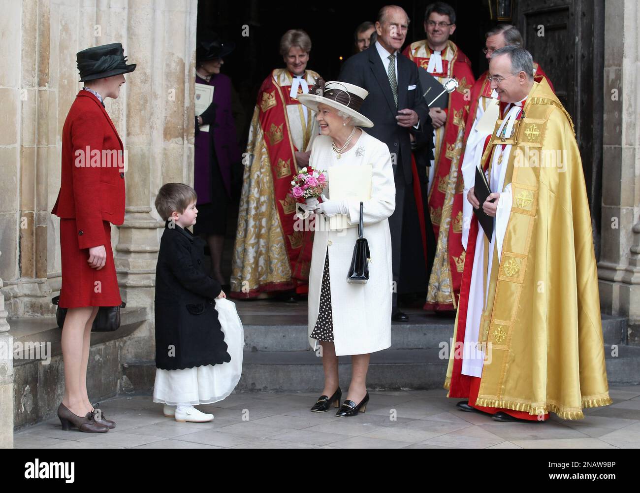 Britain's Queen Elizabeth II is presented with flowers as she leaves a ...