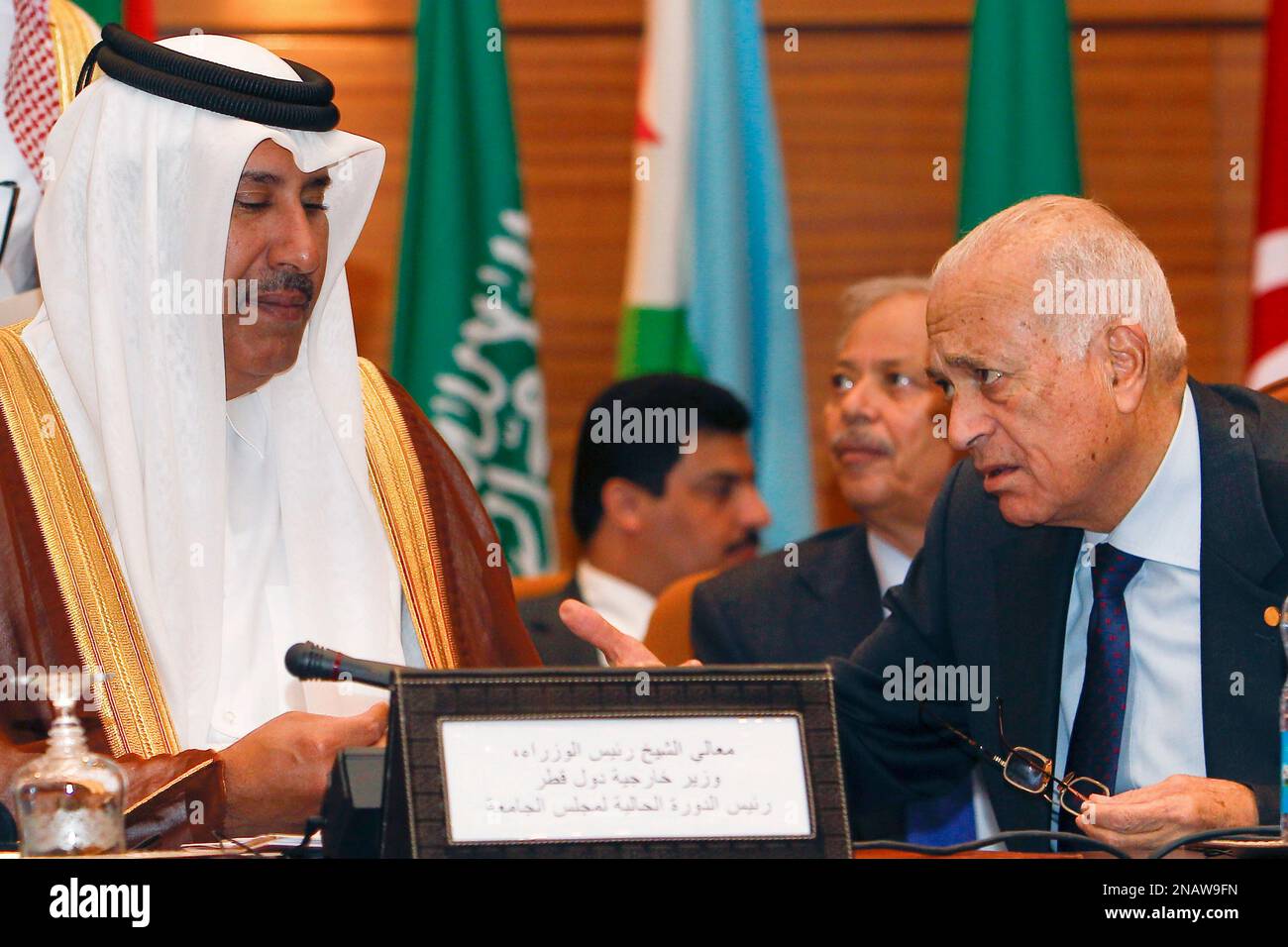 Qatari Foreign Minister Hamad bin Jassim, left, chats with Egypt's ...