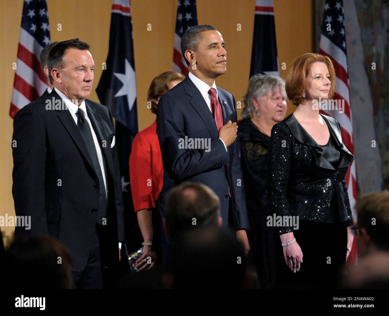 President Barack Obama, center, listens to the national anthem with ...