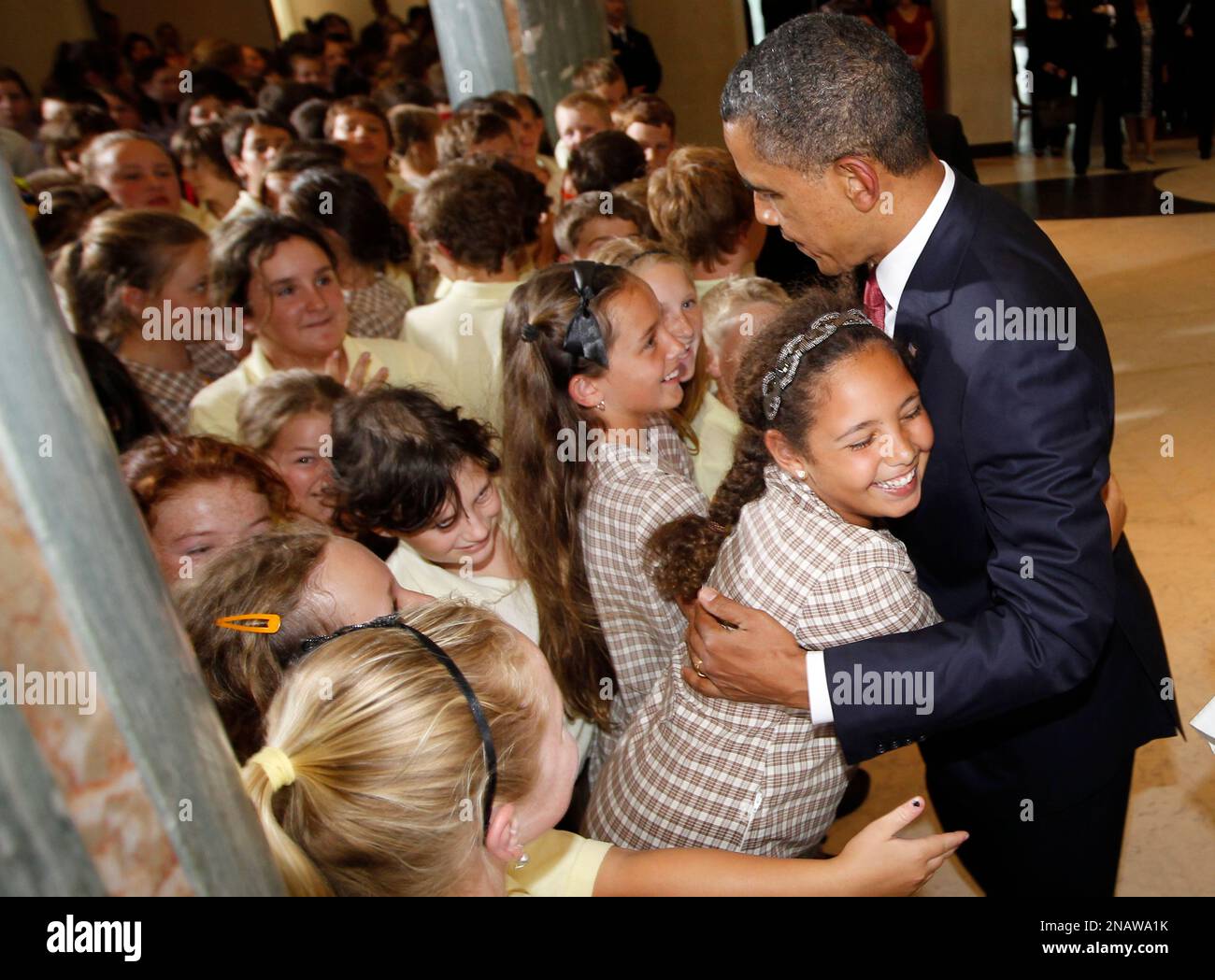 U.S. President Barack Obama gets a hug from a student at Parliament ...