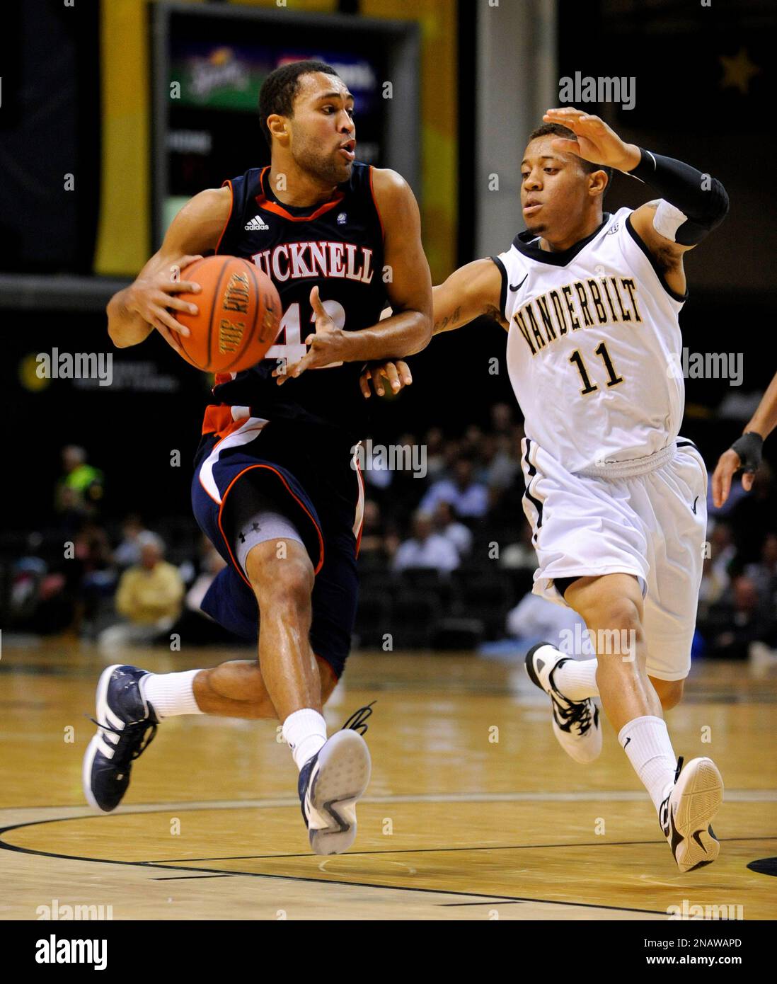 Bucknell guard Cameron Ayers runs past Vanderbilt guard Kyle Fuller (11 ...