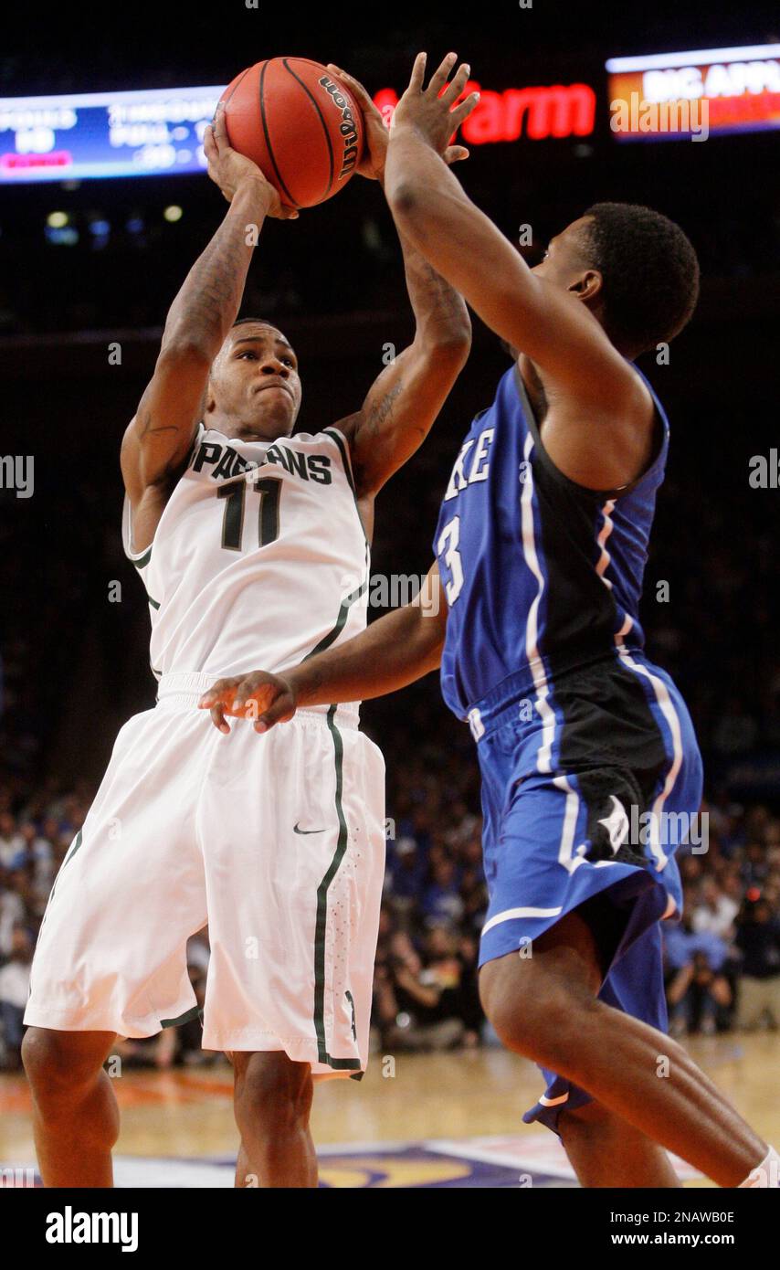 Michigan State's Keith Appling (11) shoots over Duke's Tyler Thornton ...