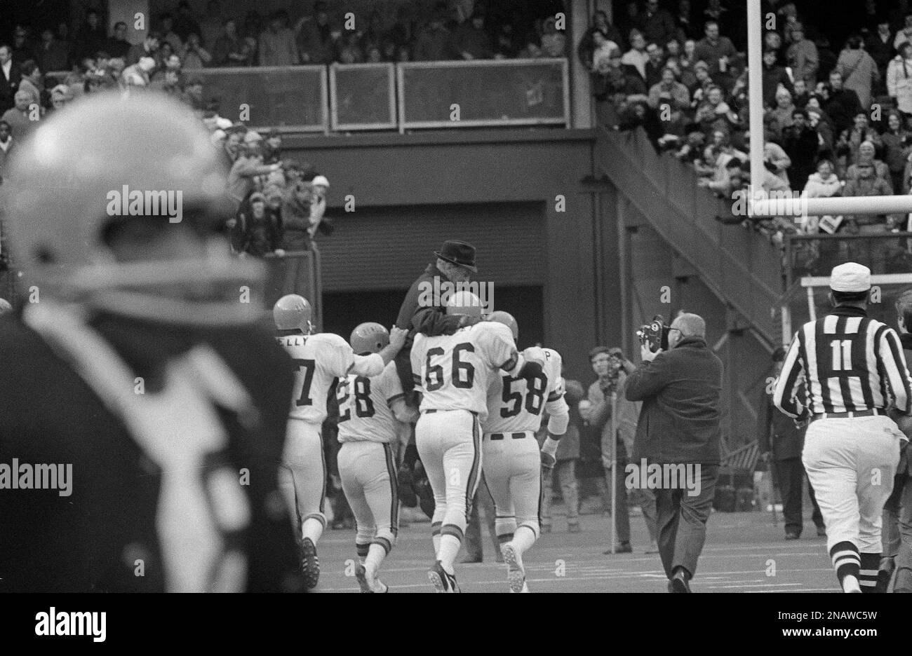 Cincinnati Bengals coach Paul Brown is hoisted by Bill Bergey (66), Al ...
