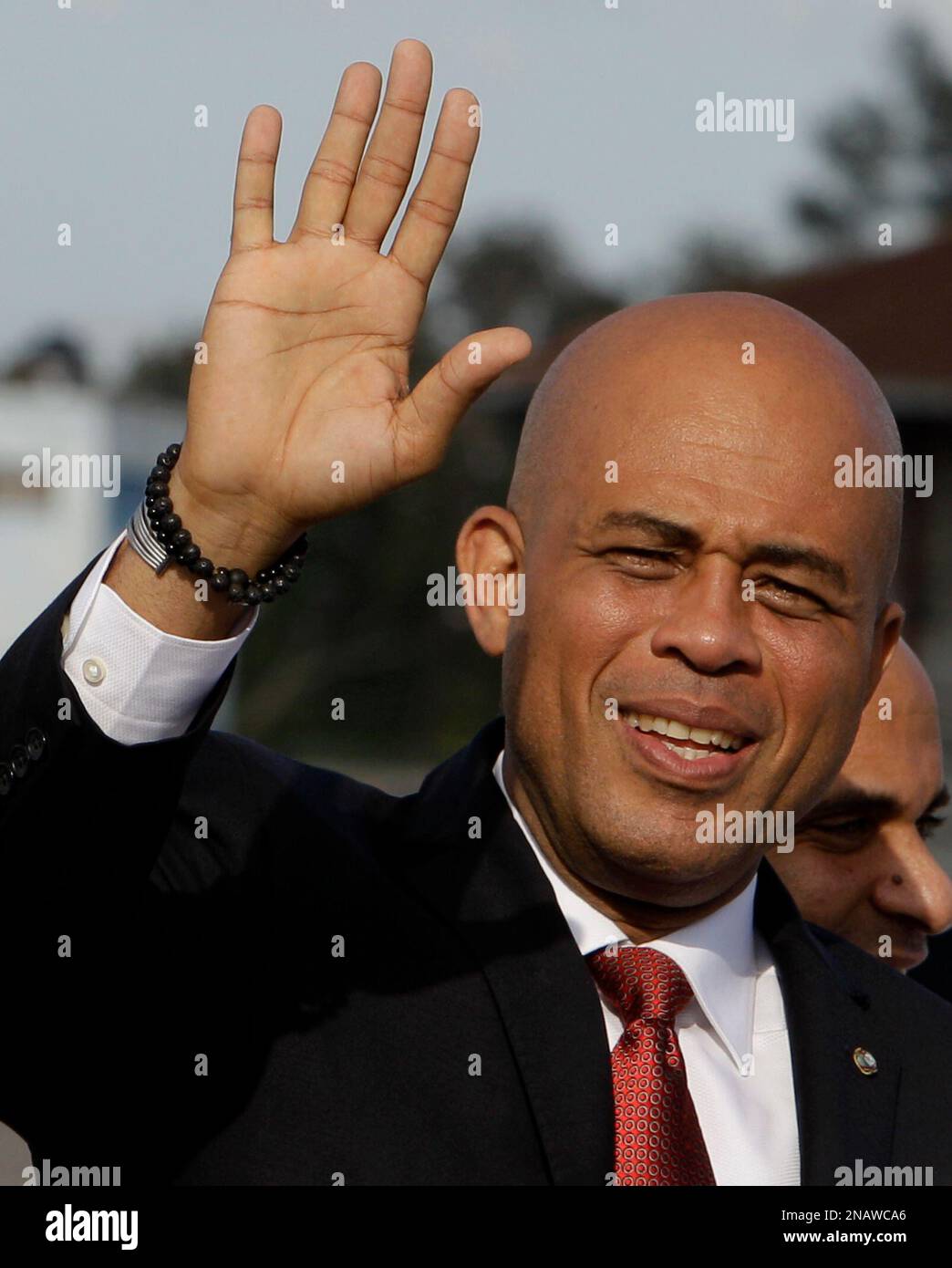 Haiti's President Michel Martelly waves to journalists upon arrival to ...