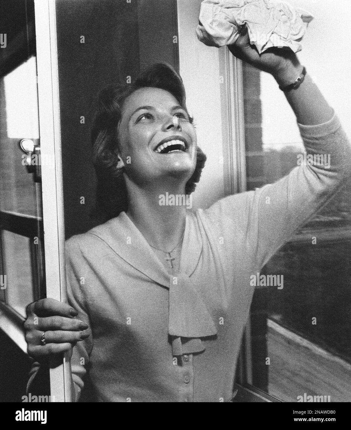 Carol Heiss, Olympic skating champion, scrubs the apartment where she ...