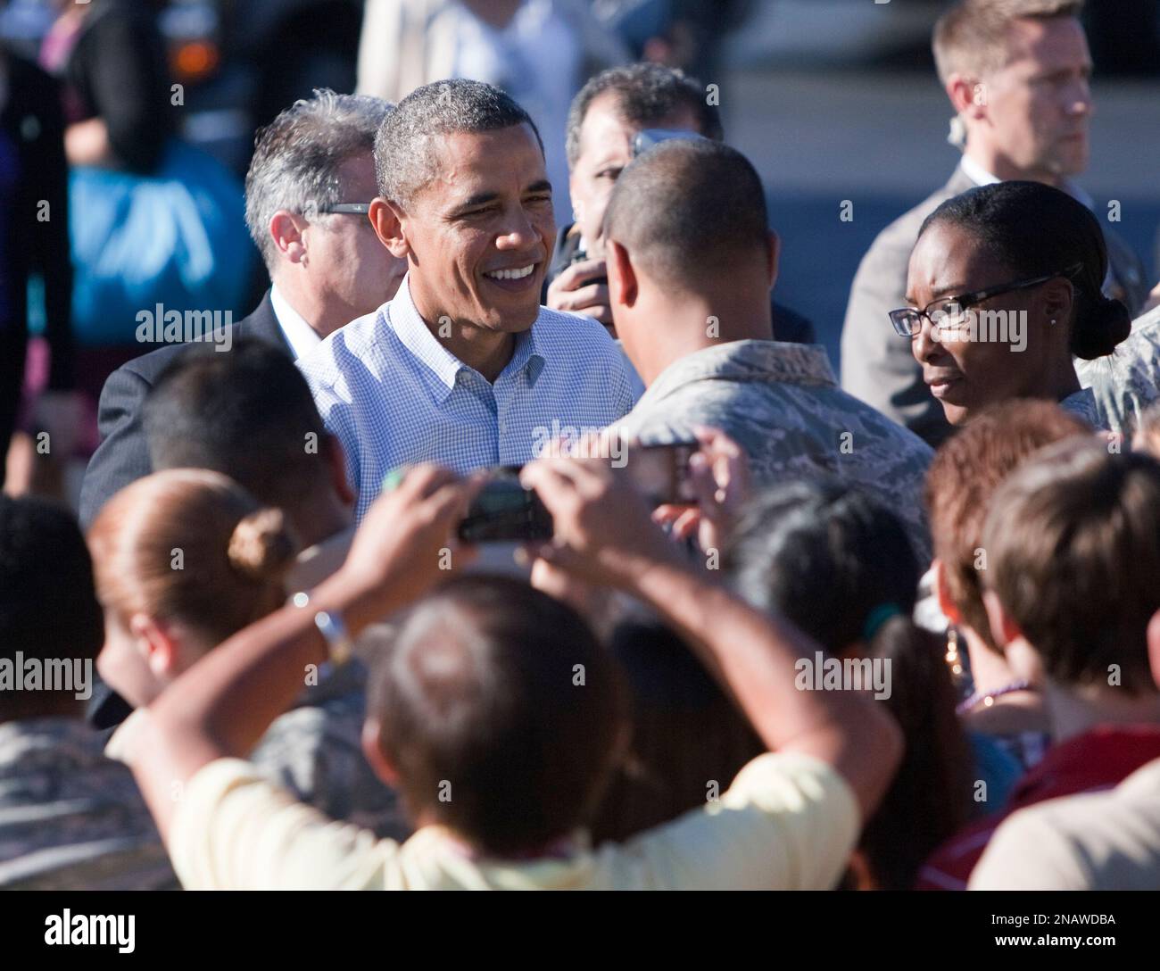 US President Barack Obama, center, greets a crowd at Joint Base Pearl ...