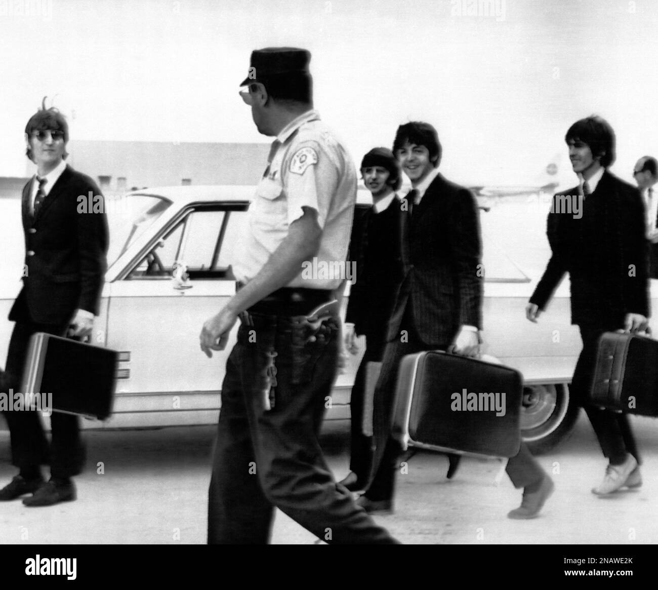 The Beatles walk through peace and quiet at Chicago’s O’Hare Airport on Thursday, August 12 ...