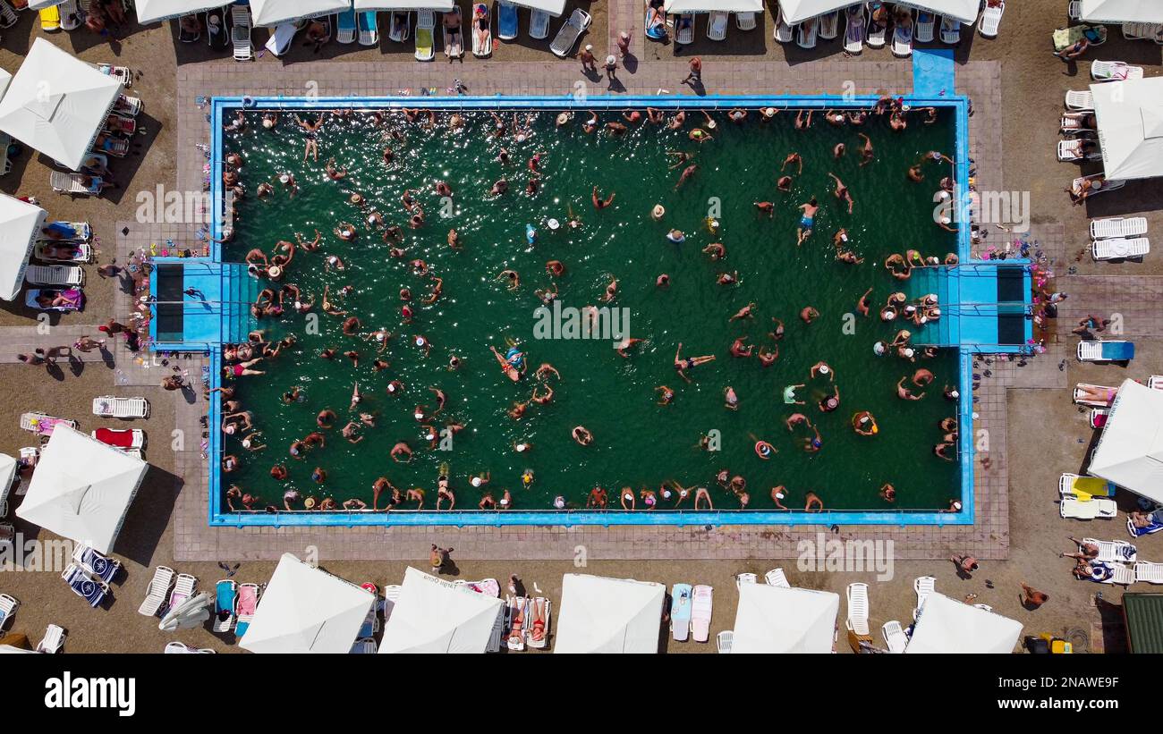 An aerial of a pool full of people swimming and having fun in Stock ...