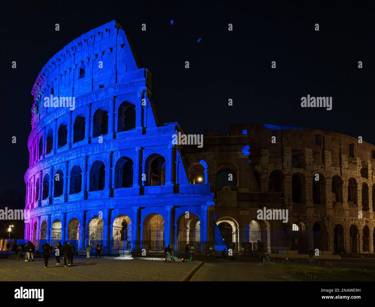 The ancient amphitheatre Colosseum captured under the blue light in ...