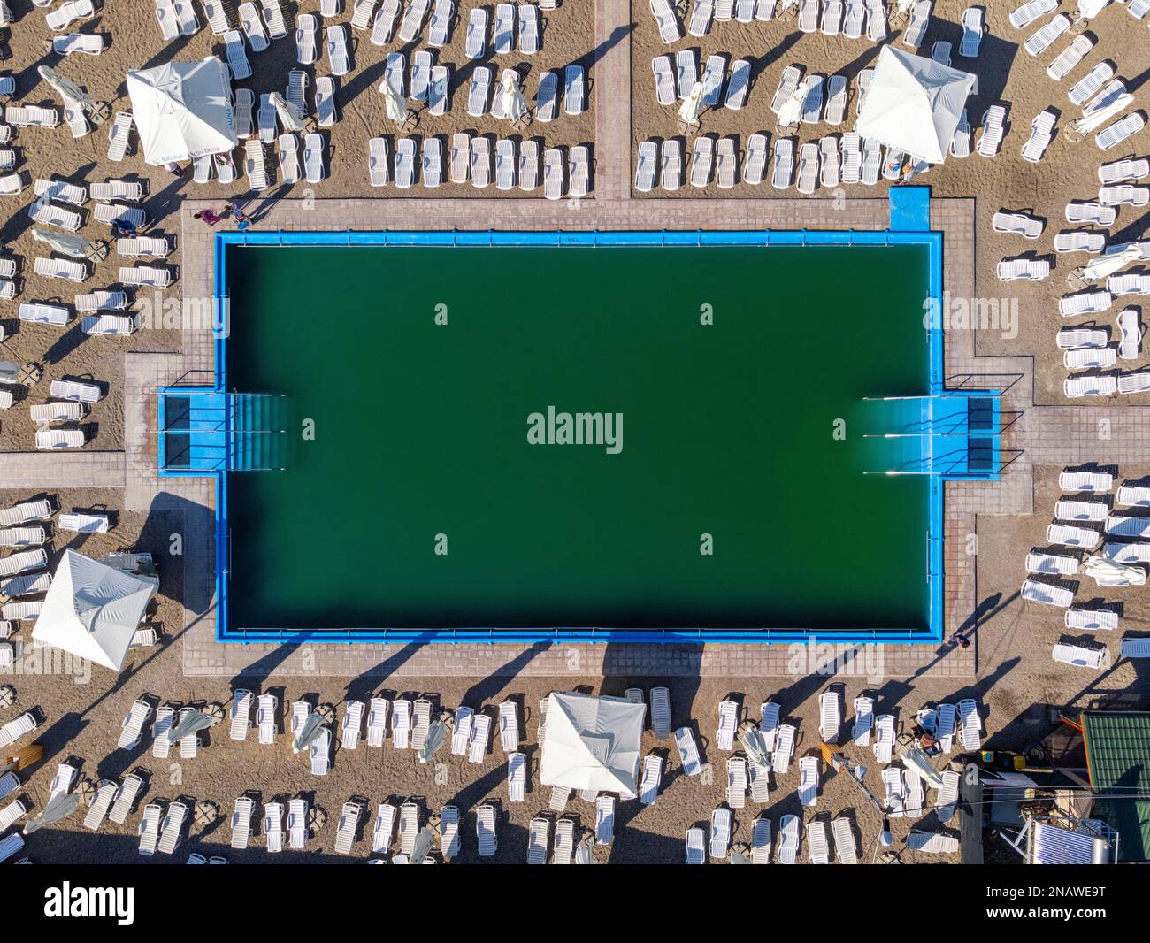 An aerial of an empty swimming pool surrounded by chairs in Targu Ocna ...