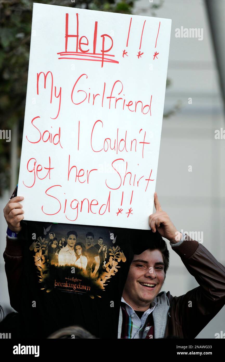 A fan holds up a sign at the beginning of the world premiere of "The ...