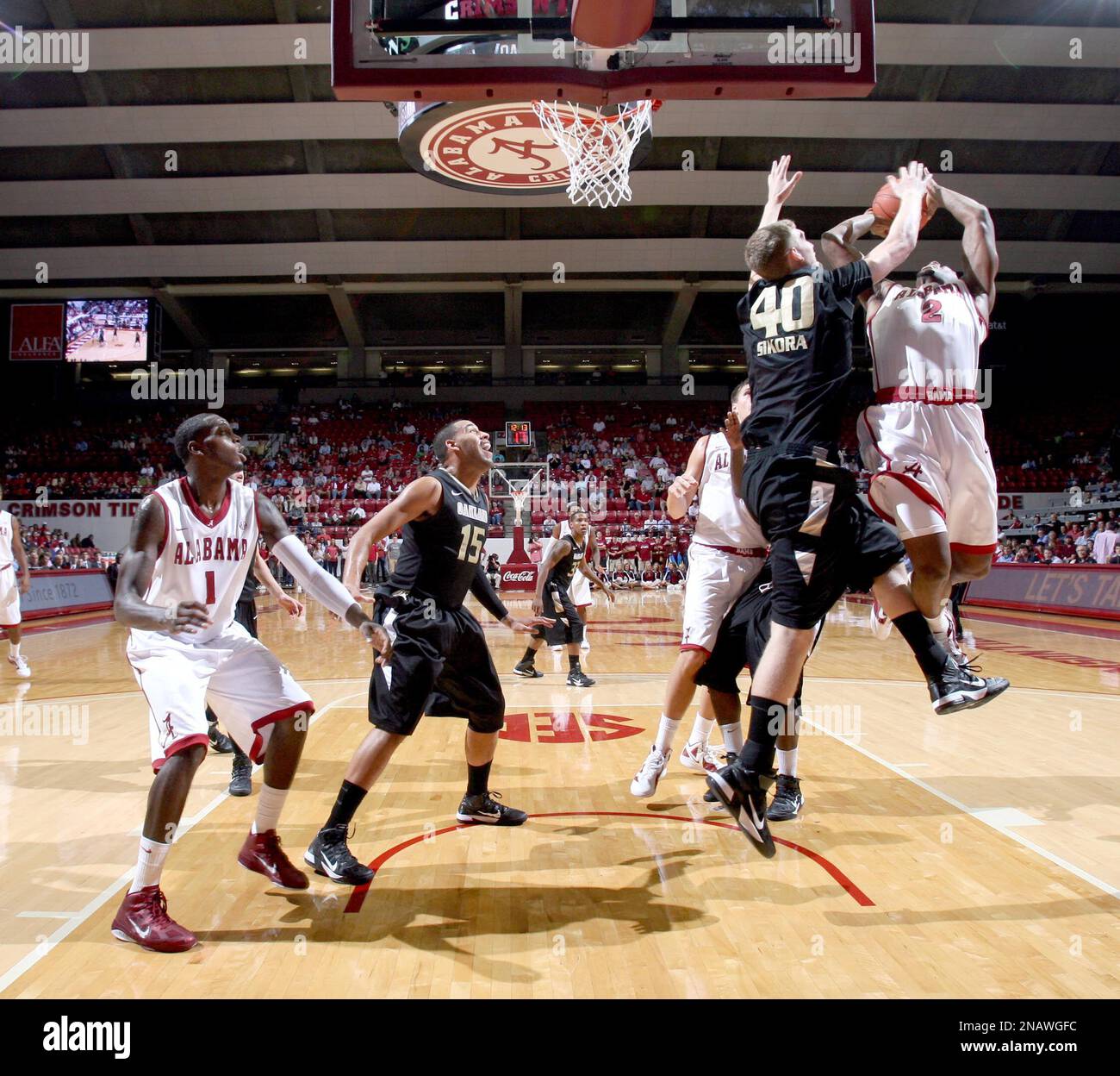Alabama's Charles Hankerson, Jr. (2) is fouled by Oakland center Kyle ...