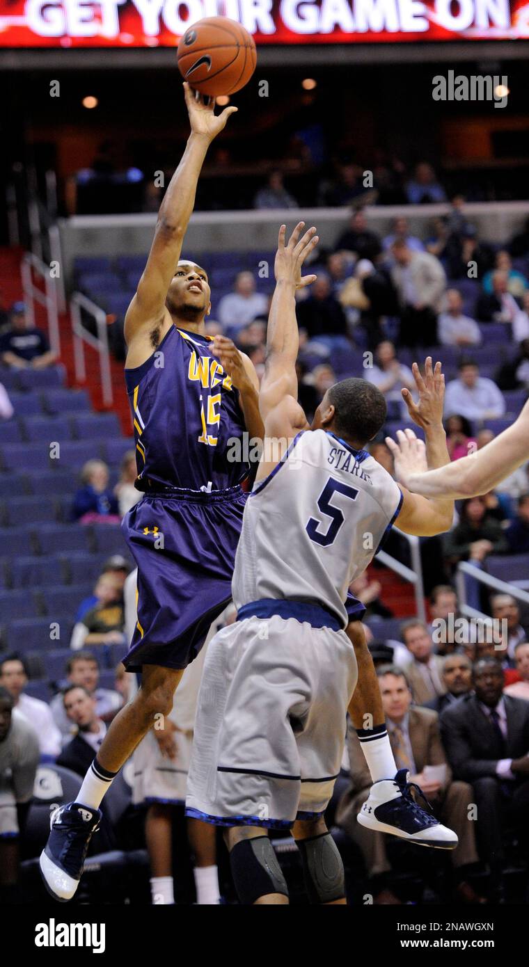 UNC-Greensboro's Trevis Simpson, left, goes to the basket against ...