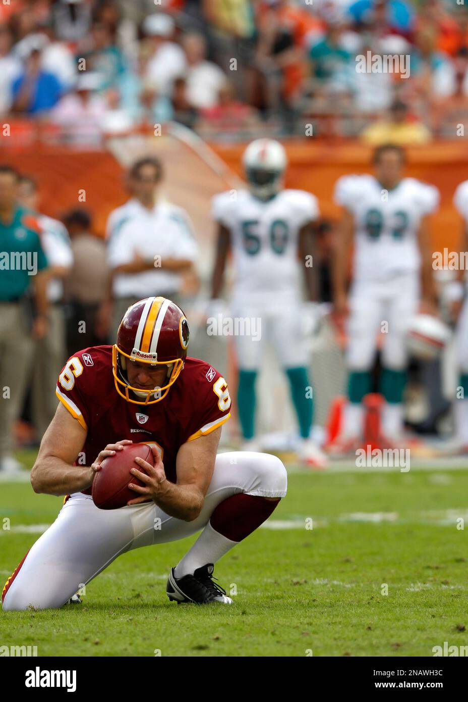 Washington Redskins punter Sav Rocca (6) puts the ball in place for ...