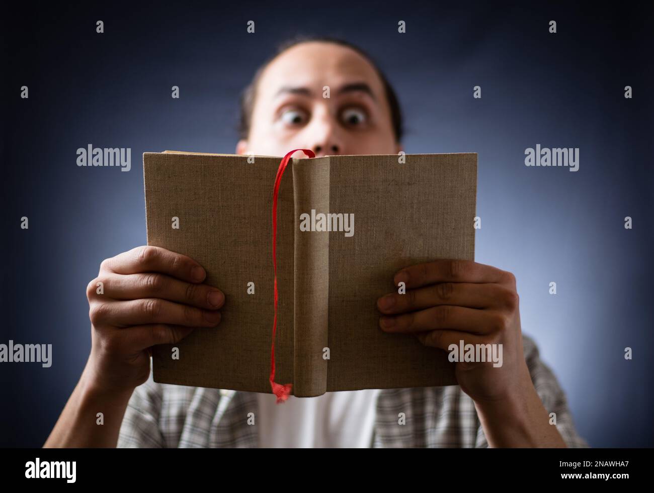 The angry student sitting on the desk with books Stock Photo - Alamy
