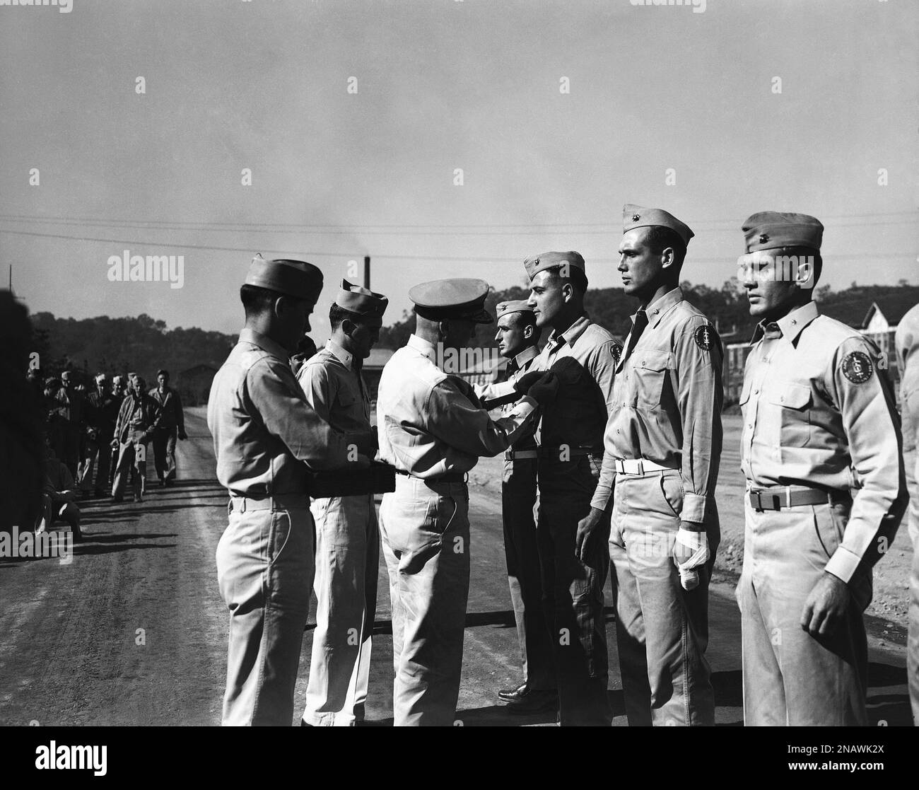 Commodore Oliver Kessing, USN, left, presented awards to these Marines ...