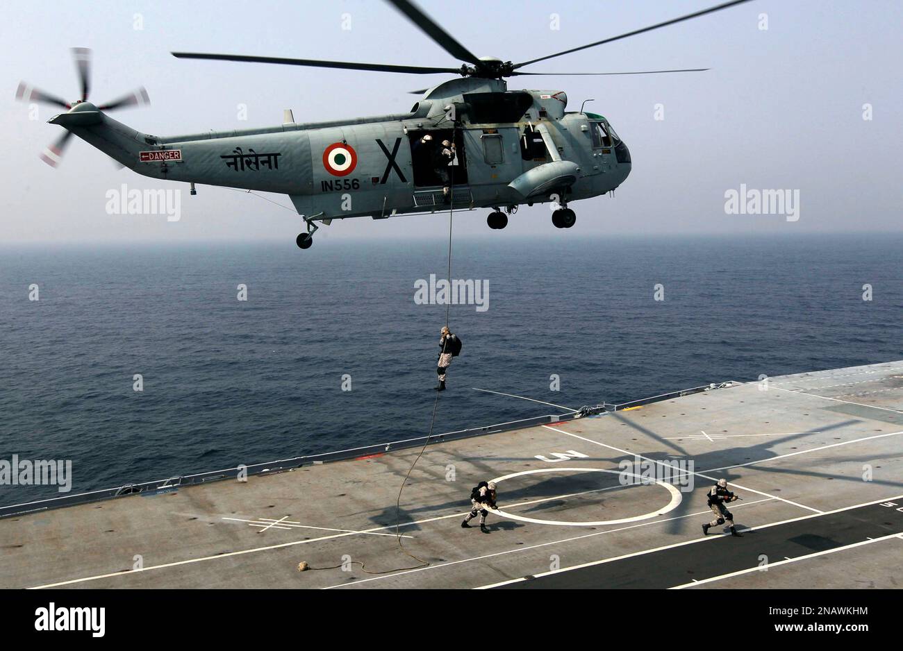 Indian Navy Marine commandoes slither down from a Sea King helicopter ...