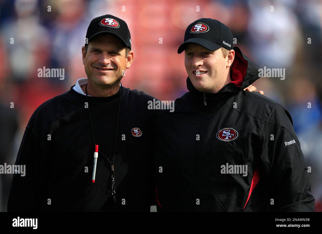 San Francisco 49ers head coach Jim Harbaugh, left, and his son Jay are ...