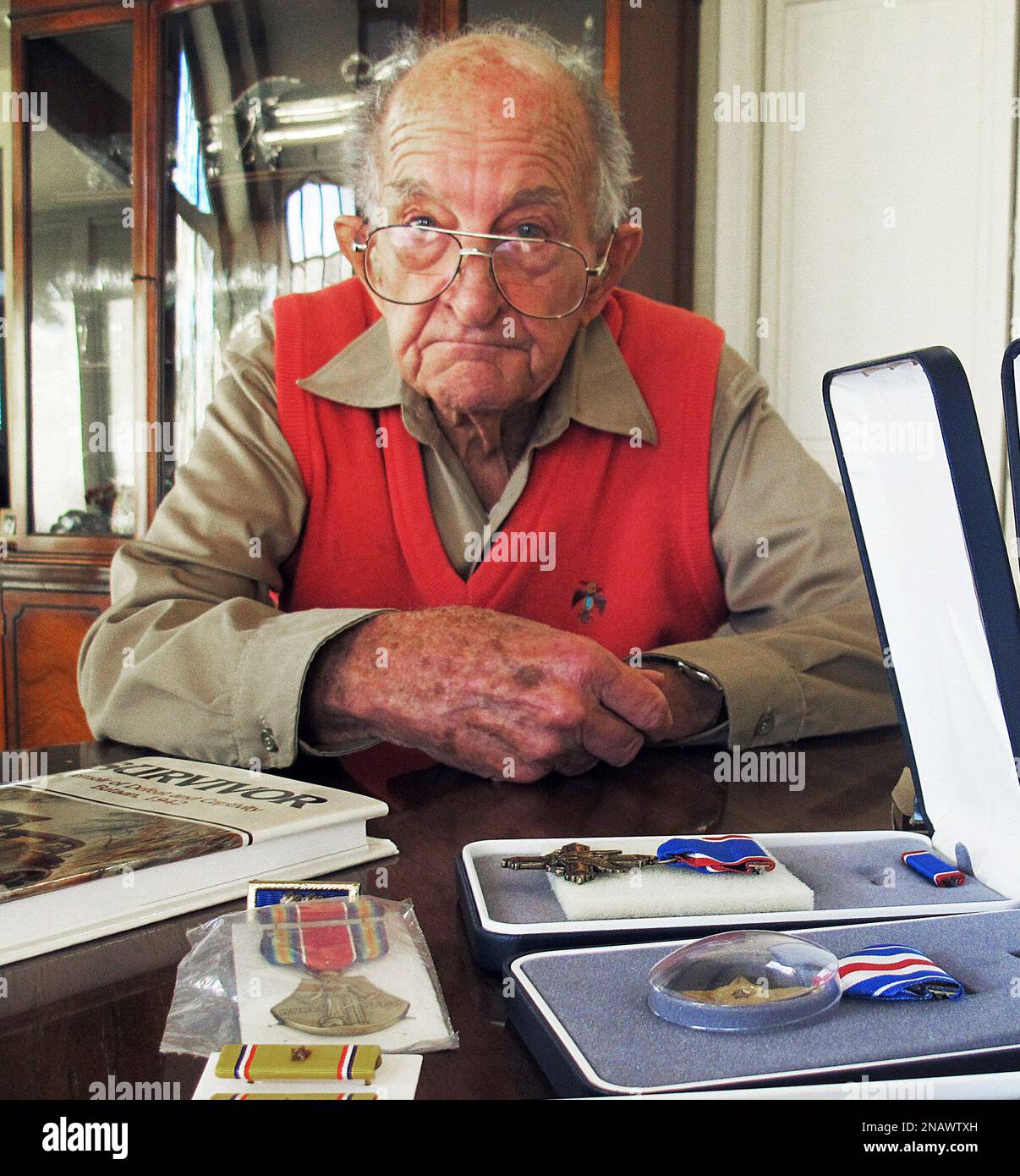 In this Nov. 10, 2011 photo, Tom Harrison, 93, displays his World War ...