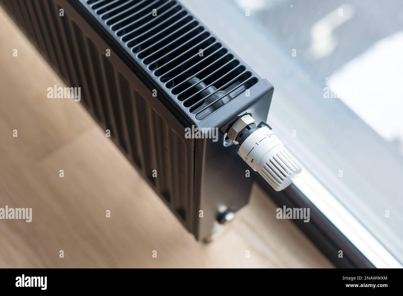 Detail of a modern black radiator under the window of a kitchen Stock ...