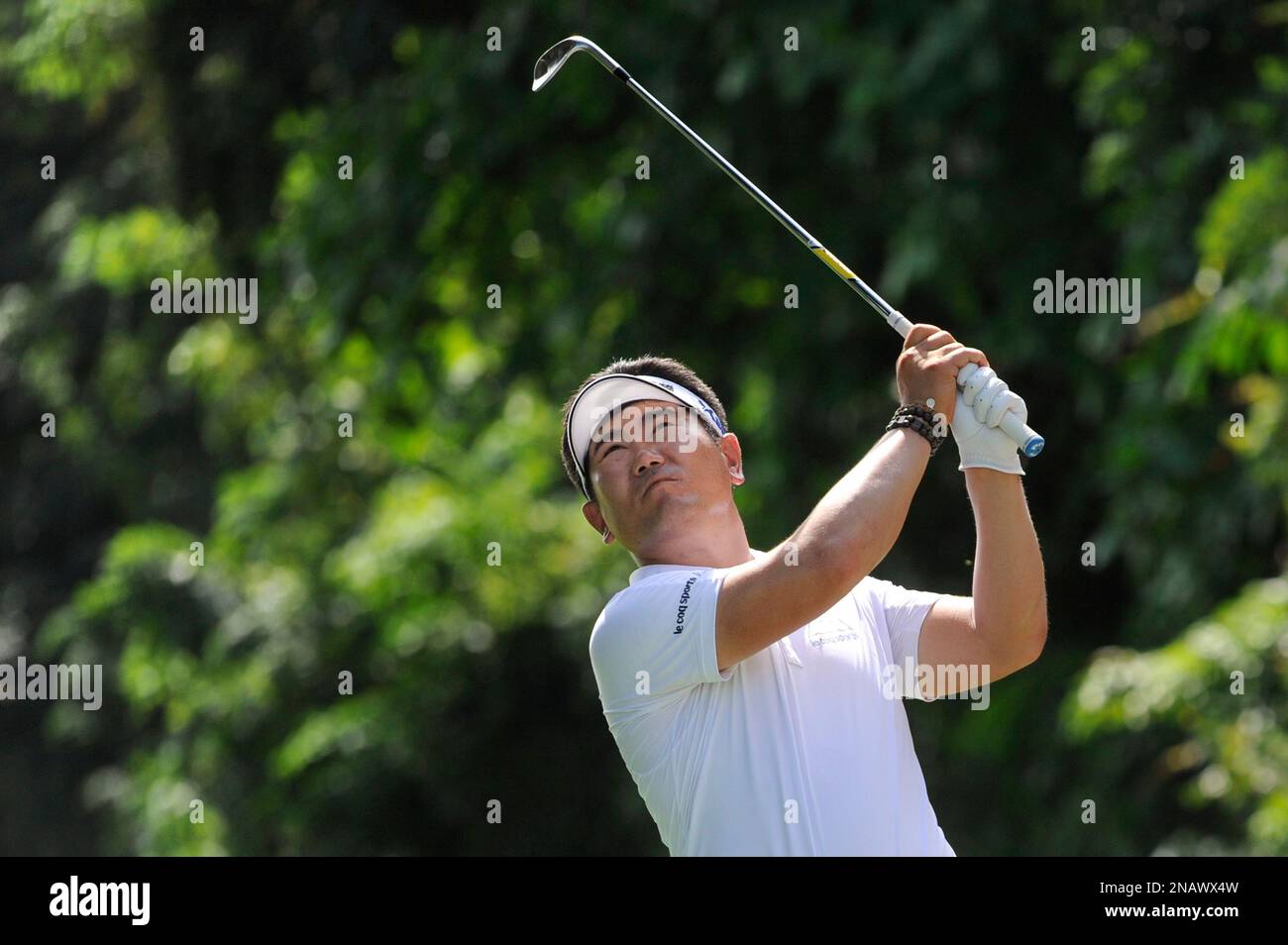South Korea's Y. E. Yang watches his ball after he hit from the rough ...