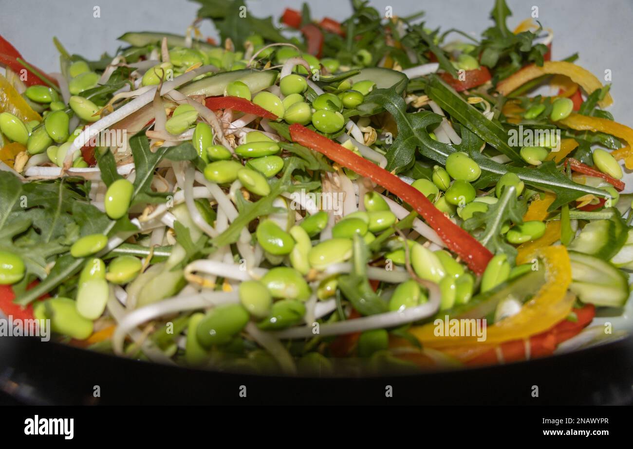 Asian style salad with a lot of fresh vegetables like taugé, edamame ...