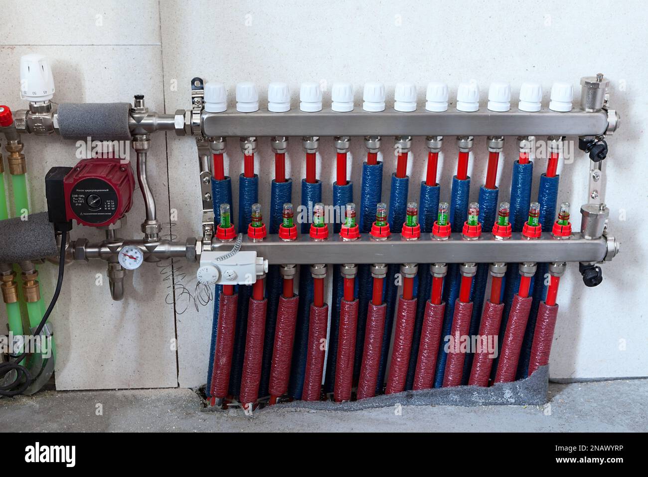 Distribution collector of a warm water floor with a mixing pump Stock ...