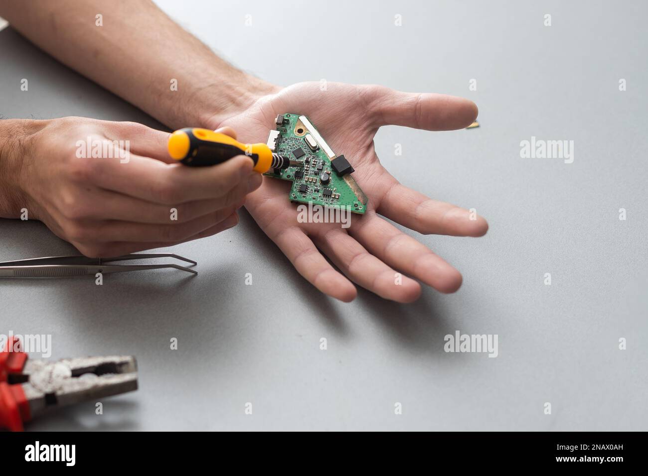 Robot arm concept. Man shows biomechanical prosthetic hand. Guy repairs ...