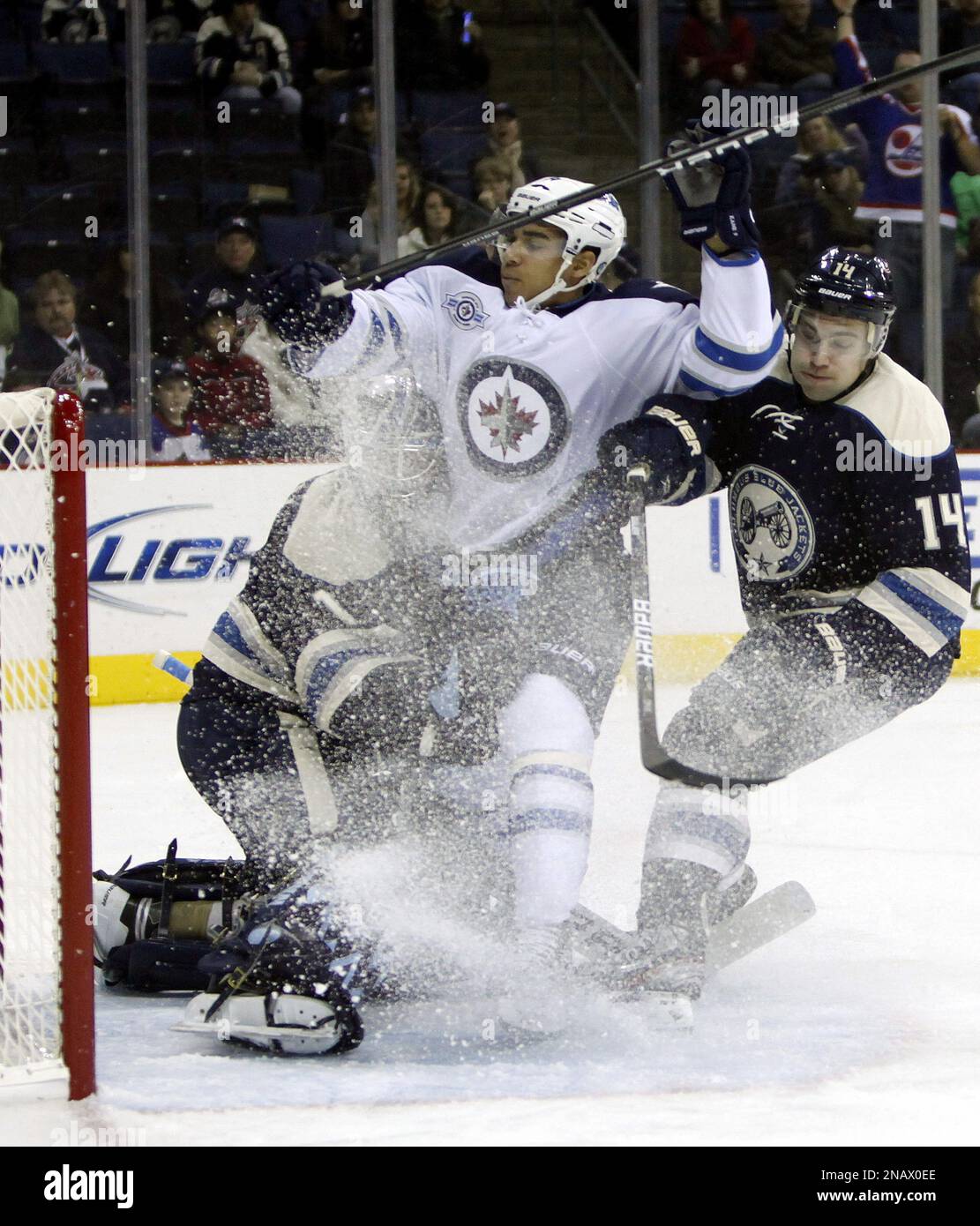 Winnipeg Jets' Evander Kane, center, is hit by Columbus Blue Jackets ...