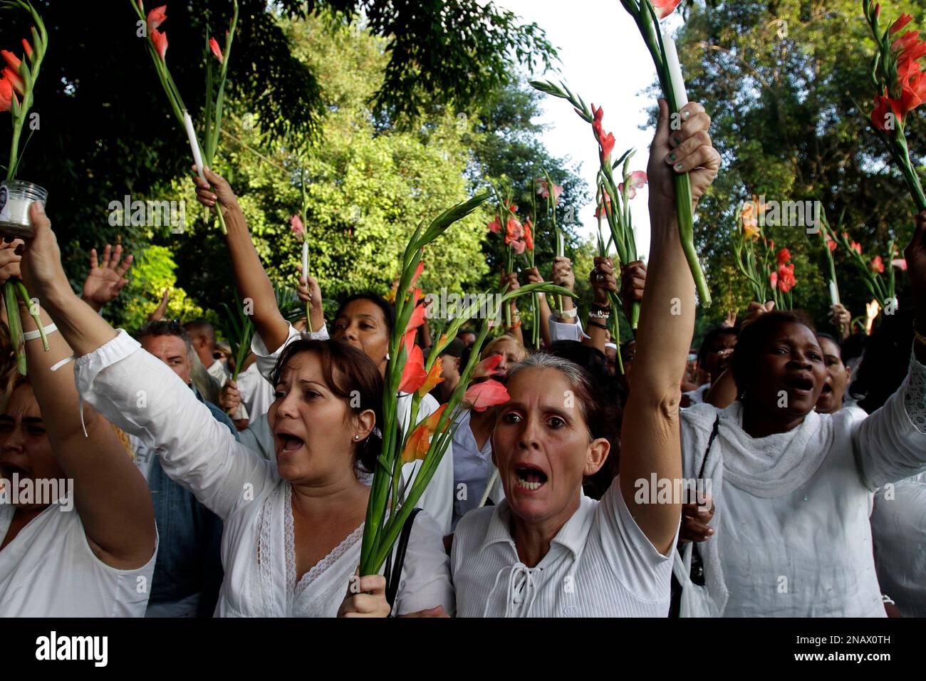 Members of Cuba's dissident group "Ladies in White" attend a procession ...