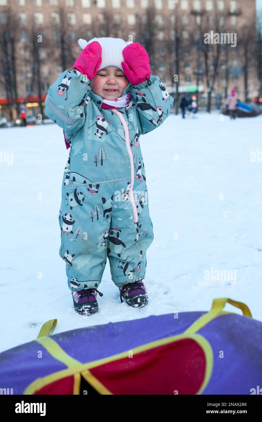 Little Girl Holds Her Head With Her Hands After Falling From A Donut little-girl-holds-her-head-with-her-hands-after-falling-from-a-donut