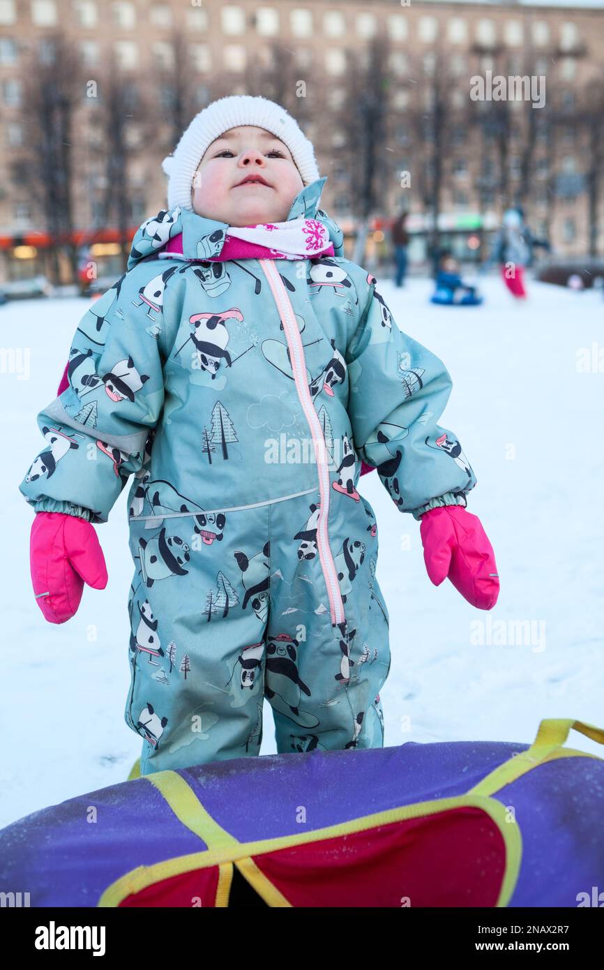 Girl rides on an inflatable rubber donut tube from a slide Stock Photo ...