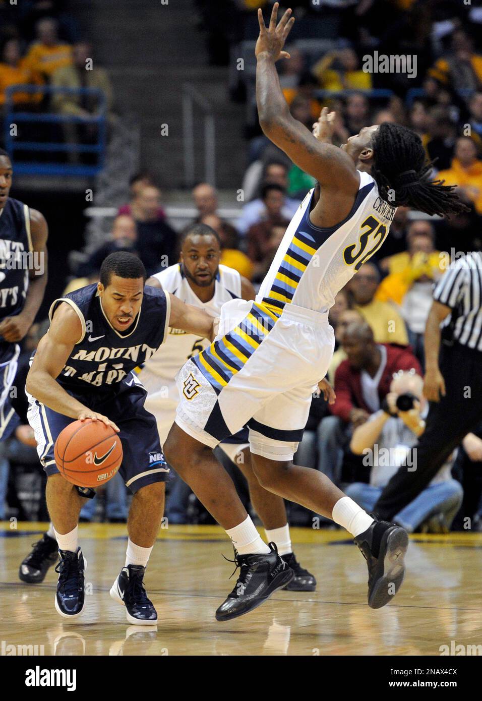 Mount St. Mary's guard Chad Holley, left, drives around Marquette ...