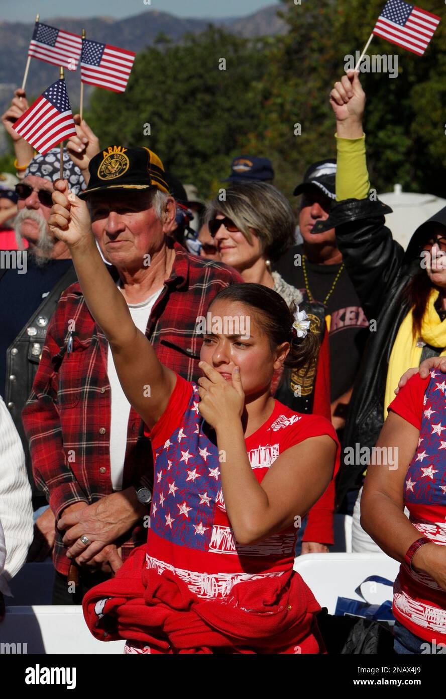 Leona Kuehnl, 28, center, waves her flag during the 52nd Veteran's Day ...