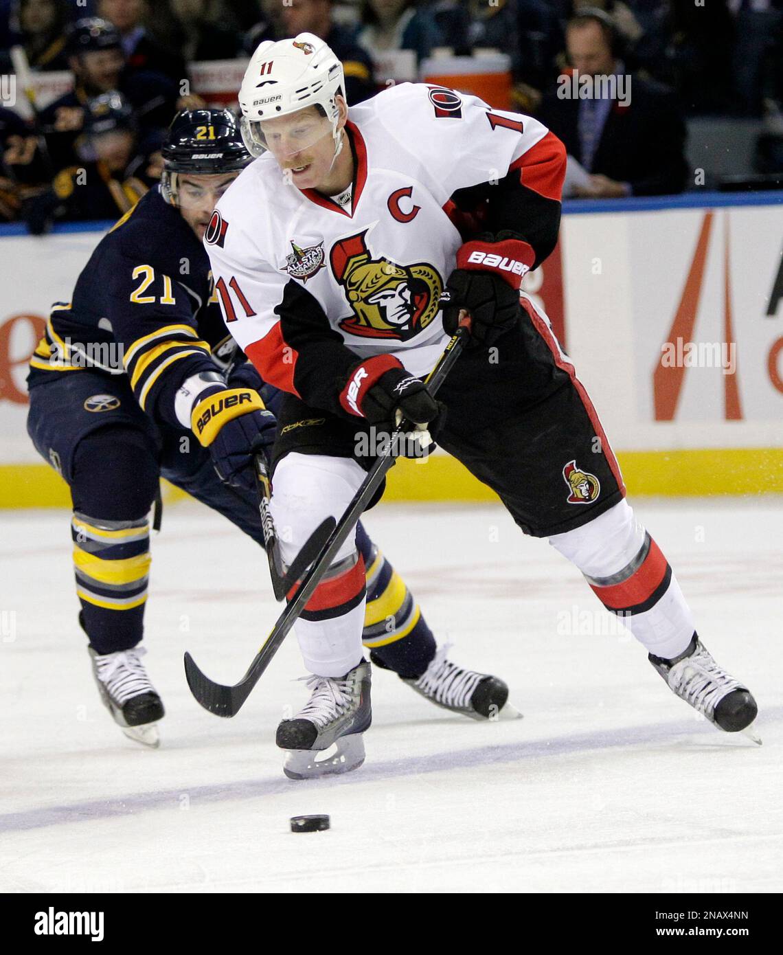 Buffalo Sabres' Drew Stafford (21) battles for the puck with Ottawa ...