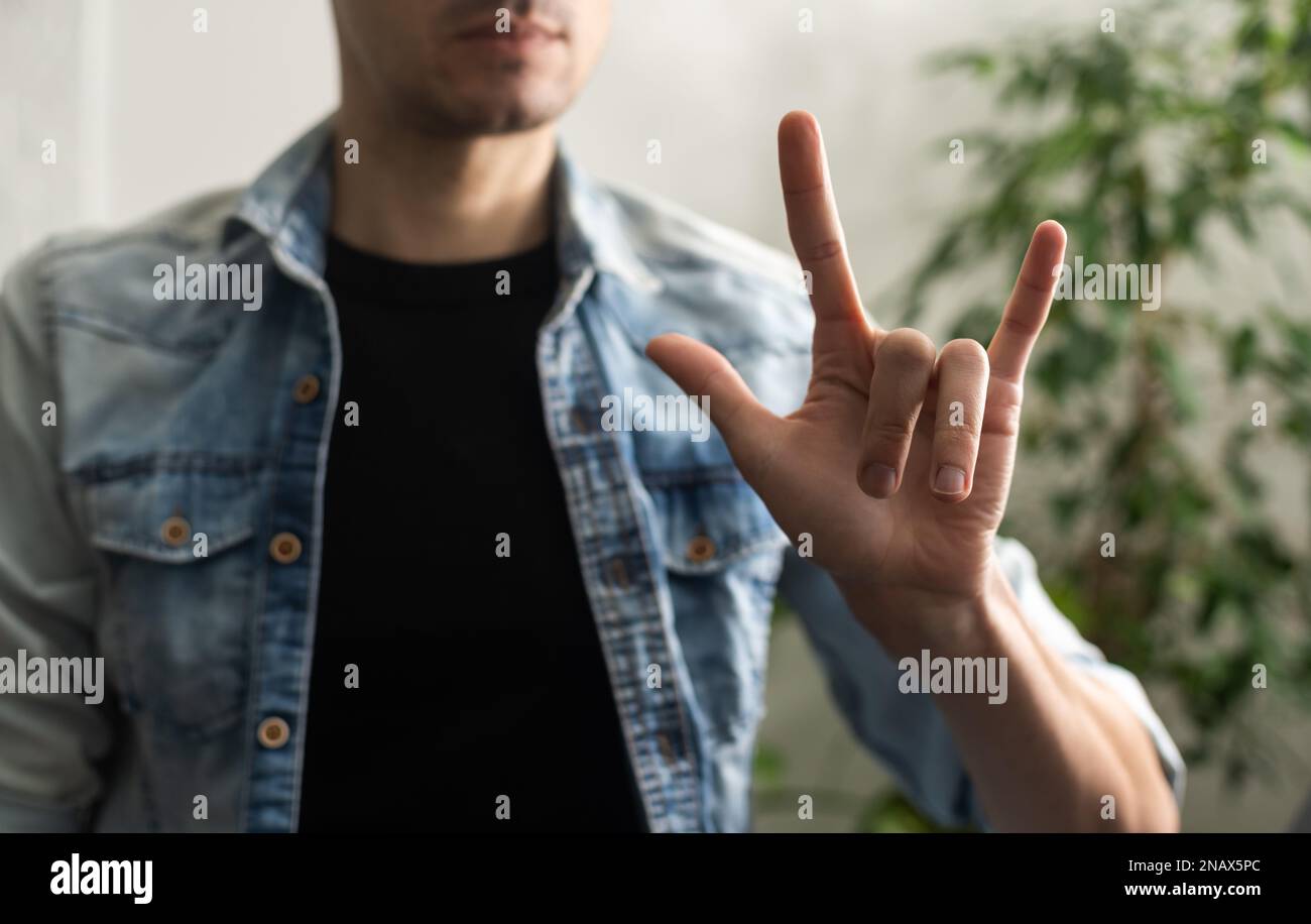 Man showing gesture in sign language on white background Stock Photo ...