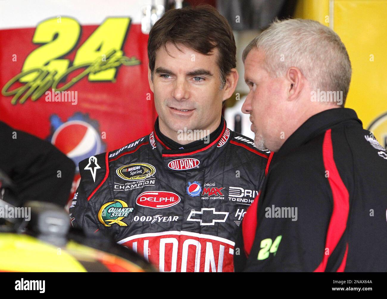 Jeff Gordon, left, talks with a crew member in the garage area prior to ...