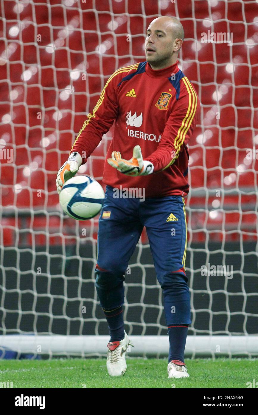 Spain's goalkeeper Jose Reina throws the ball during a training session ...
