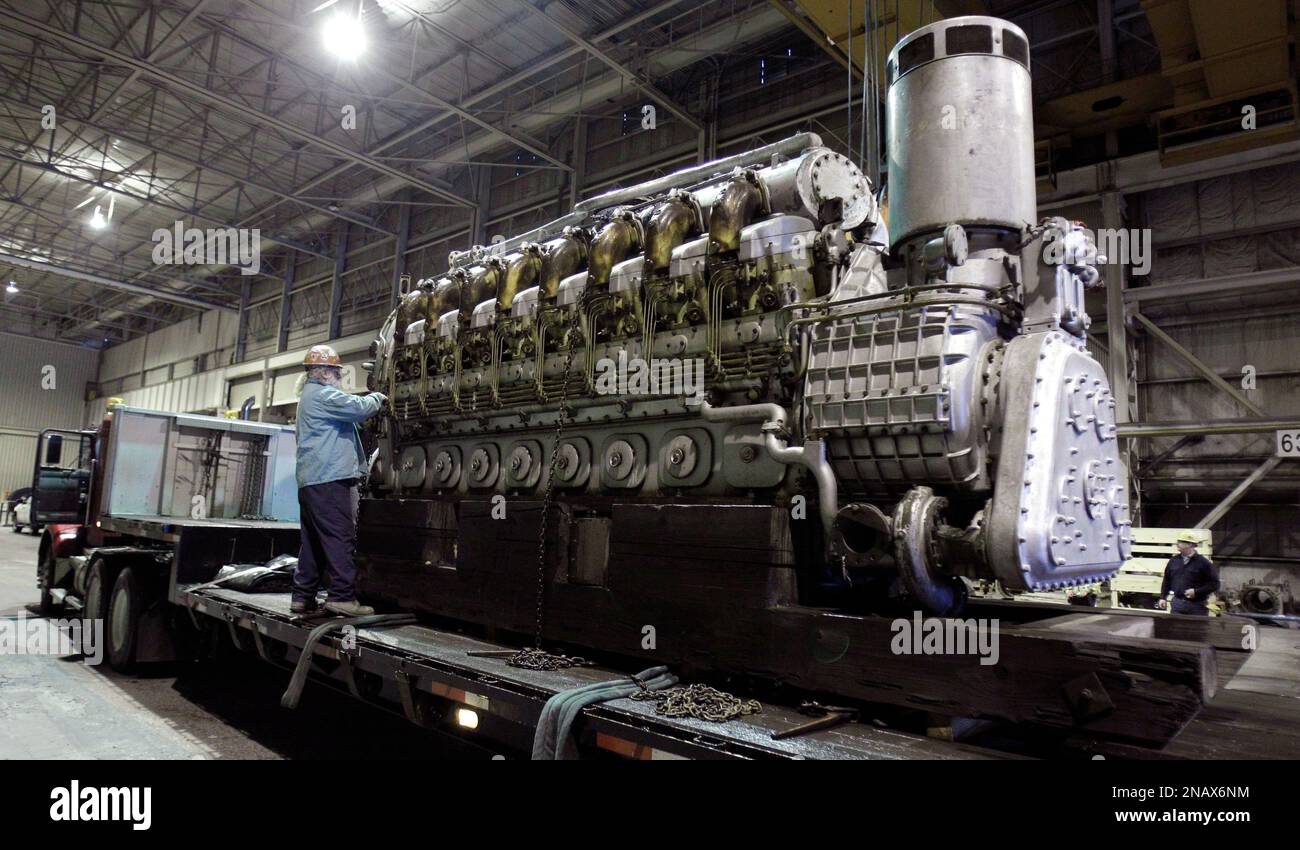 Marty Martin unhooks one of two WWII submarine diesel engines before ...
