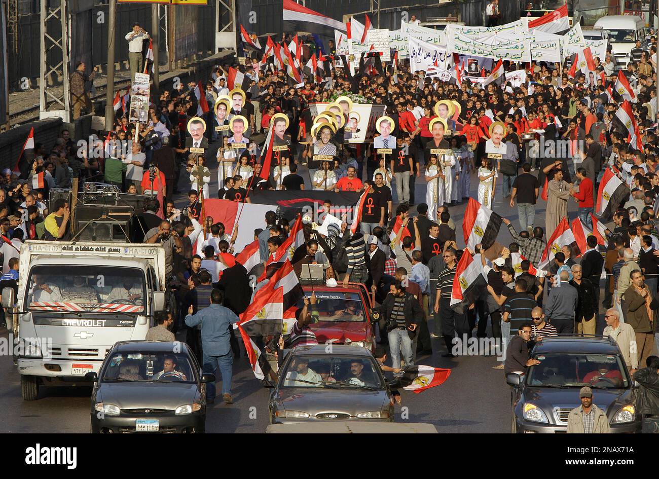 Egyptians, mainly Copts, march in Cairo, holding national flags and ...