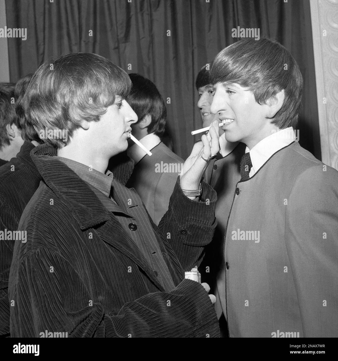 Beatle drummer Ringo Starr eases the pain on a wax likeness of himself ...