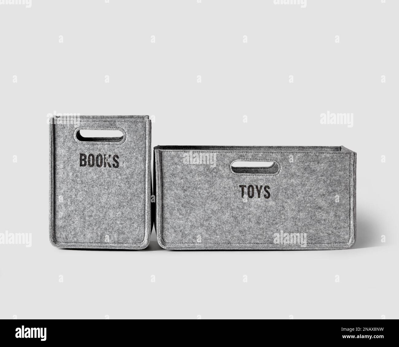 Handcrafted gray felt boxes for storing books and toys Stock Photo - Alamy
