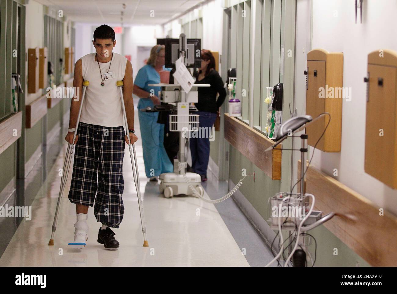 Hosan Mohamed, a wounded 21 year-old Libyan freedom fighter, walks down ...