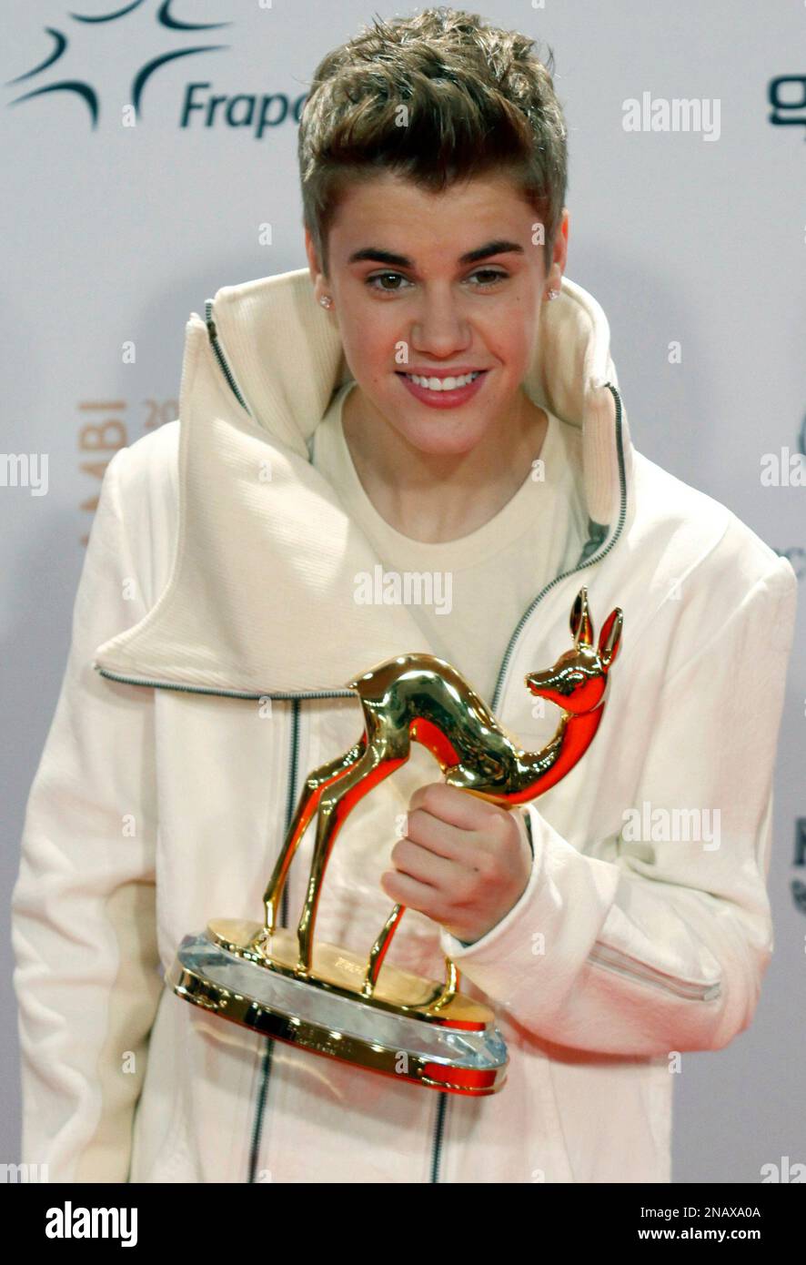Canadian singer Justin Bieber presents the trophy for best ...